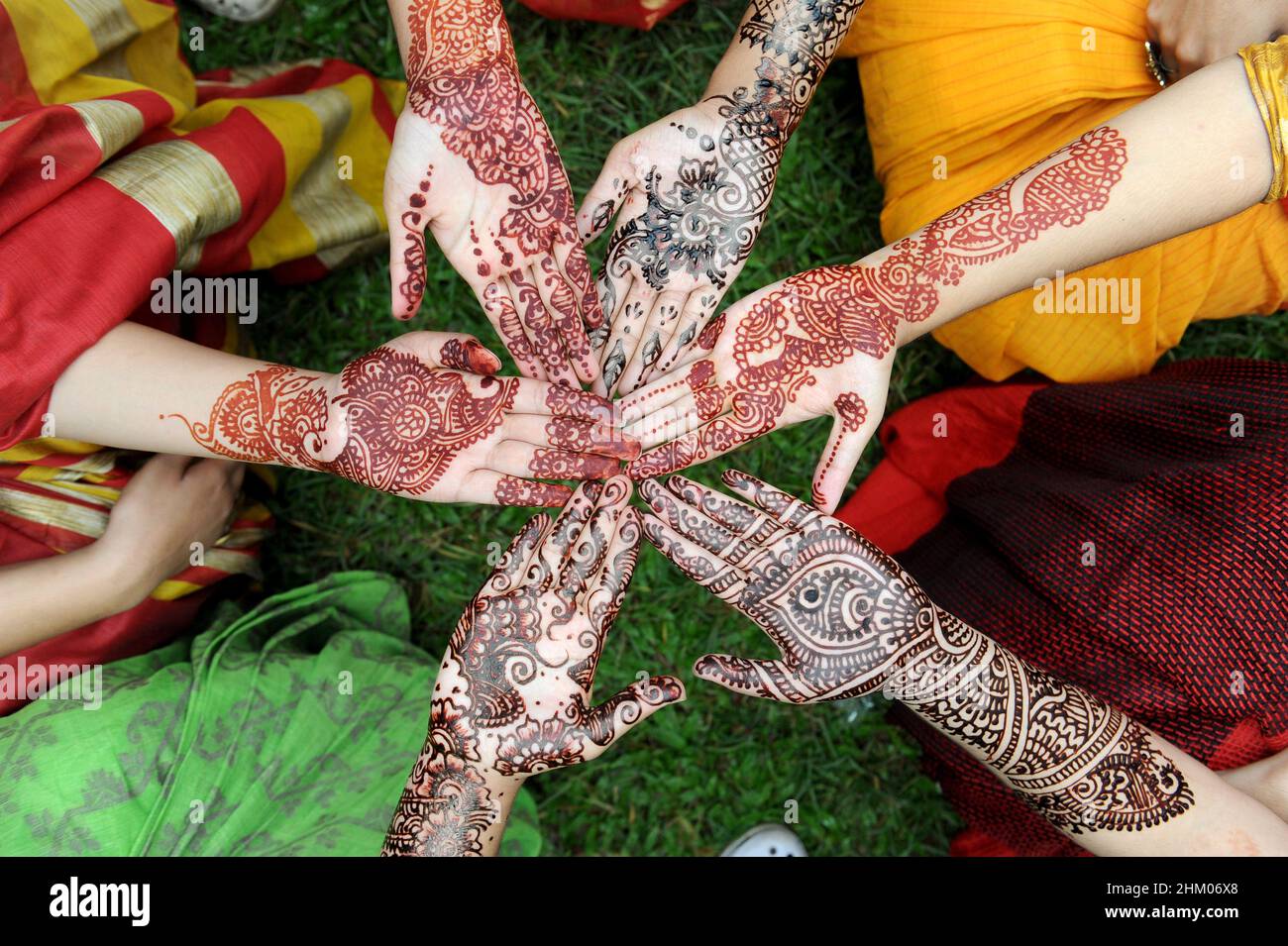 Dhaka, Bangladesh - June 11, 2016: Bangladeshi girls arts her hand with Henna during the Eid ...