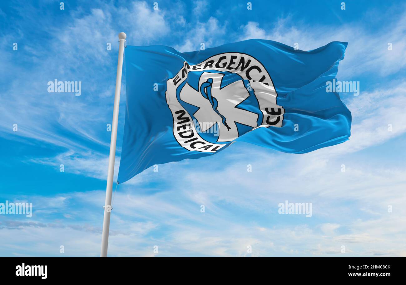 Emergency Medical Services flag waving at sky background on sunset ...