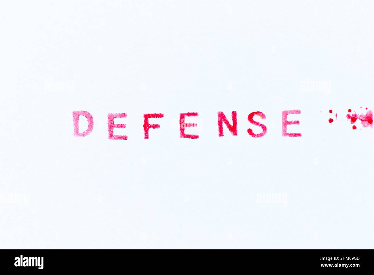 Red color ink rubber stamp in word defense on white paper background ...