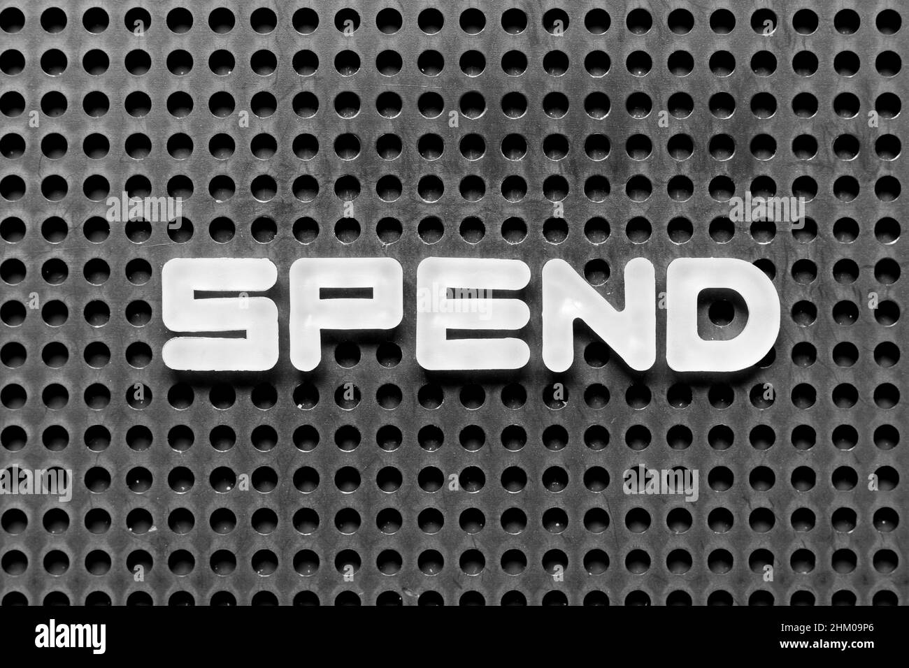 White alphabet letter in word spend on black pegboard background Stock ...