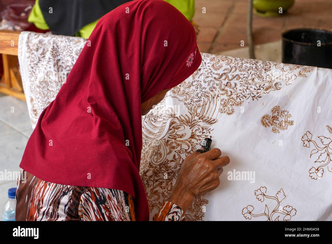 The technique of making batik by writing using a canting tool. Canting ...