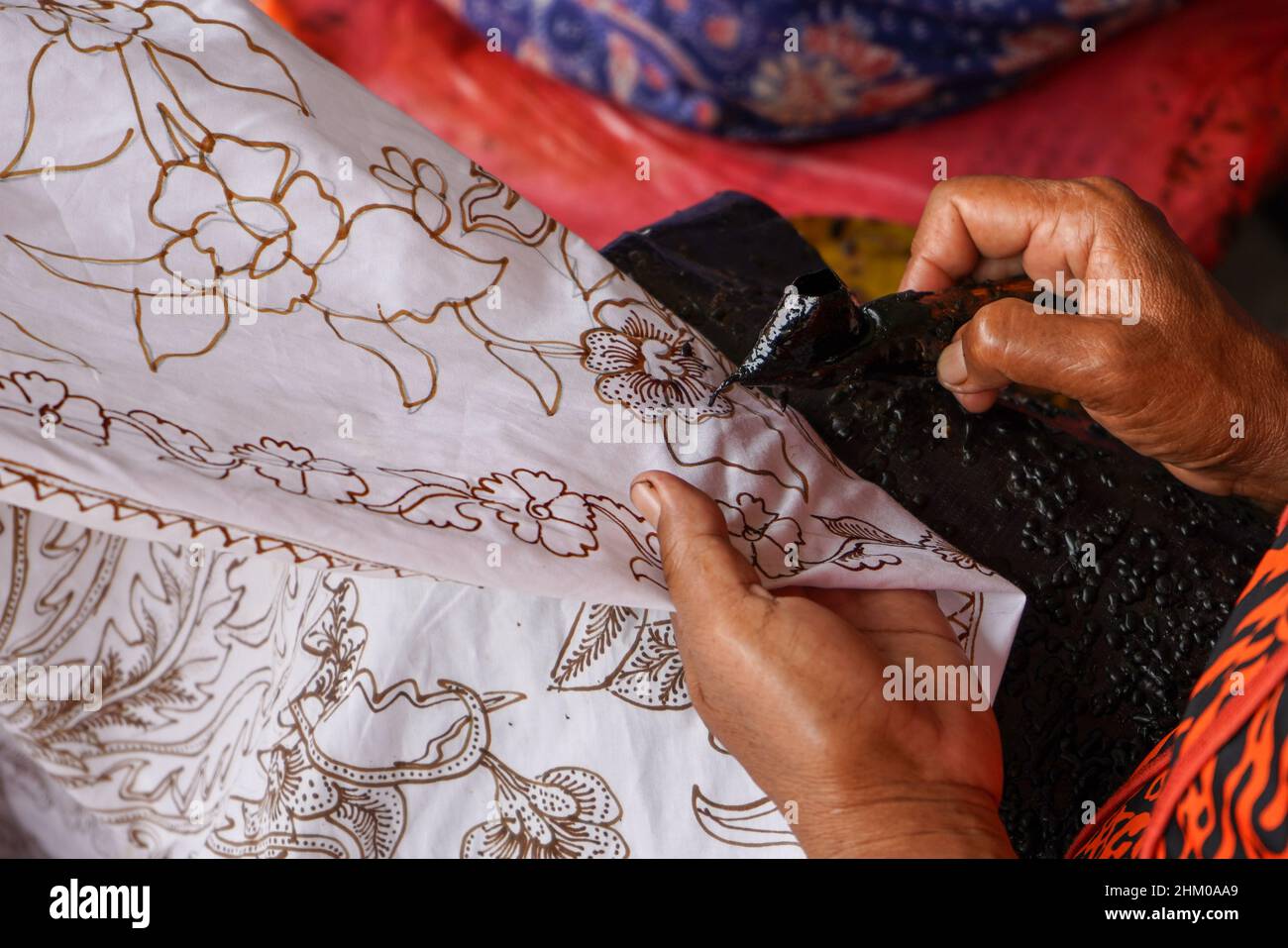 The technique of making batik by writing using a canting tool. Canting ...