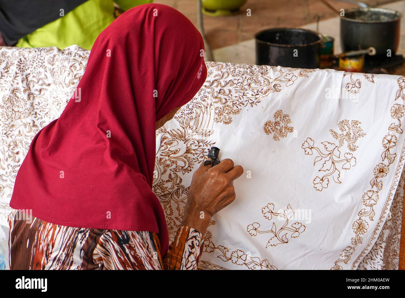 The technique of making batik by writing using a canting tool. Canting ...
