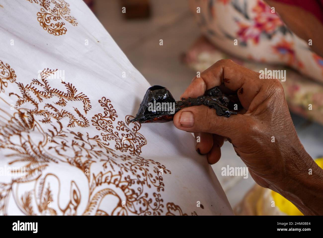 The technique of making batik by writing using a canting tool. Canting ...