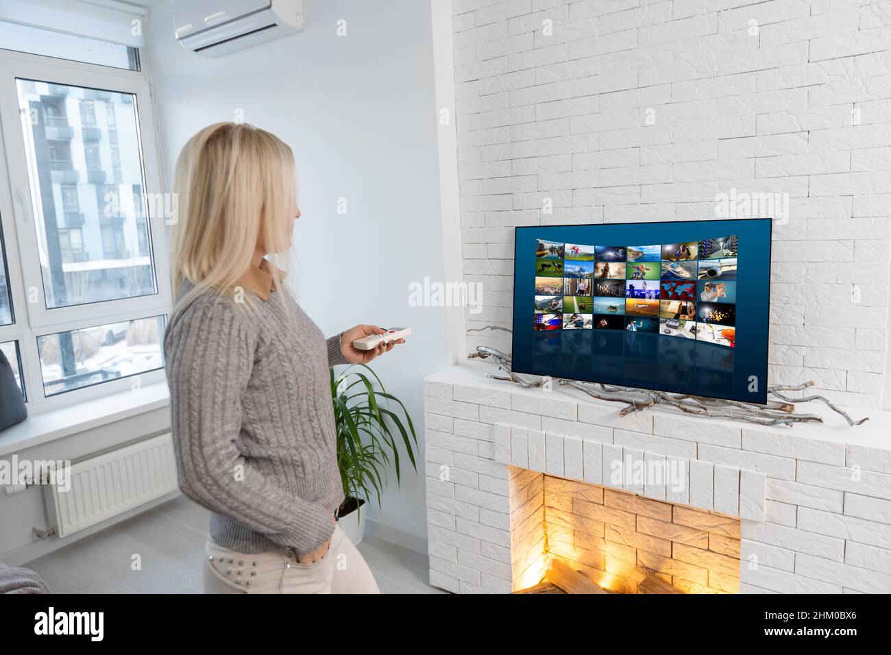 Close-up Of A Woman Changing The Channel With Remote Control While ...
