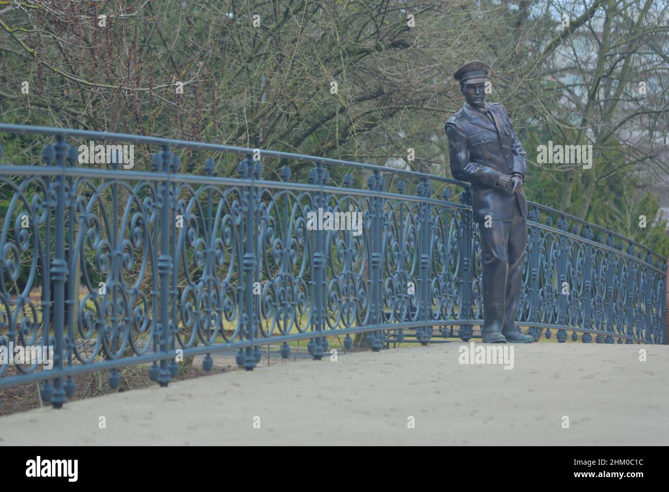 Statue and life size figure of Elvis Presley leaning on bridge railing ...