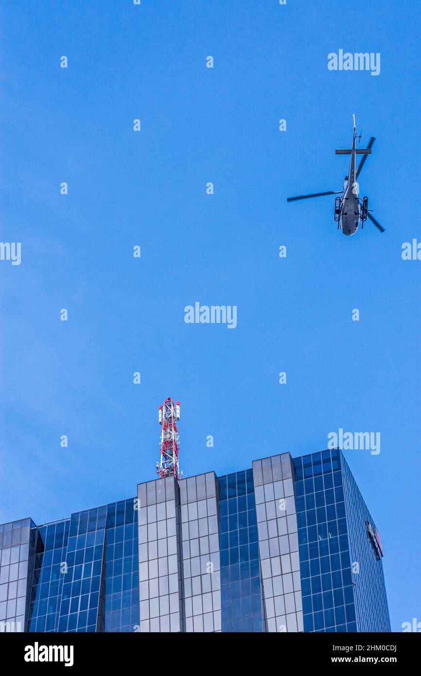 Wien, Vienna: helicopter in front of skyscraper DC Tower 1, reflecting ...