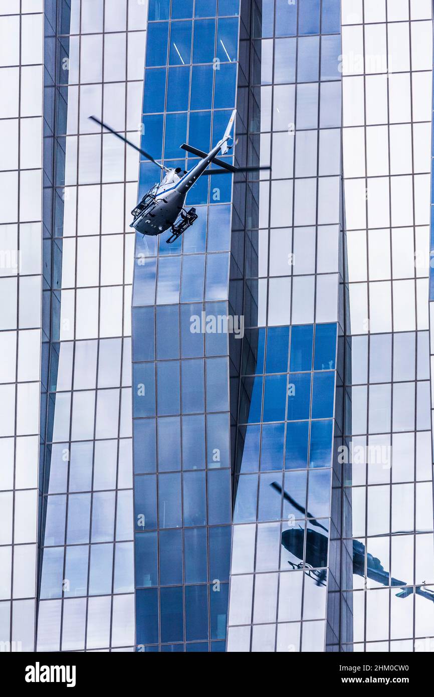 Wien, Vienna: helicopter in front of skyscraper DC Tower 1, reflecting ...