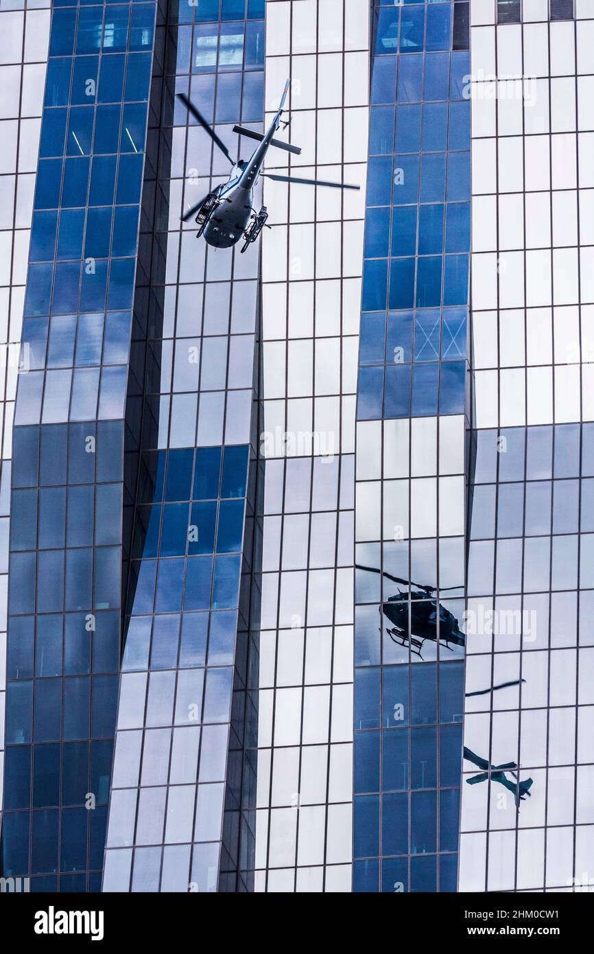 Wien, Vienna: helicopter in front of skyscraper DC Tower 1, reflecting ...