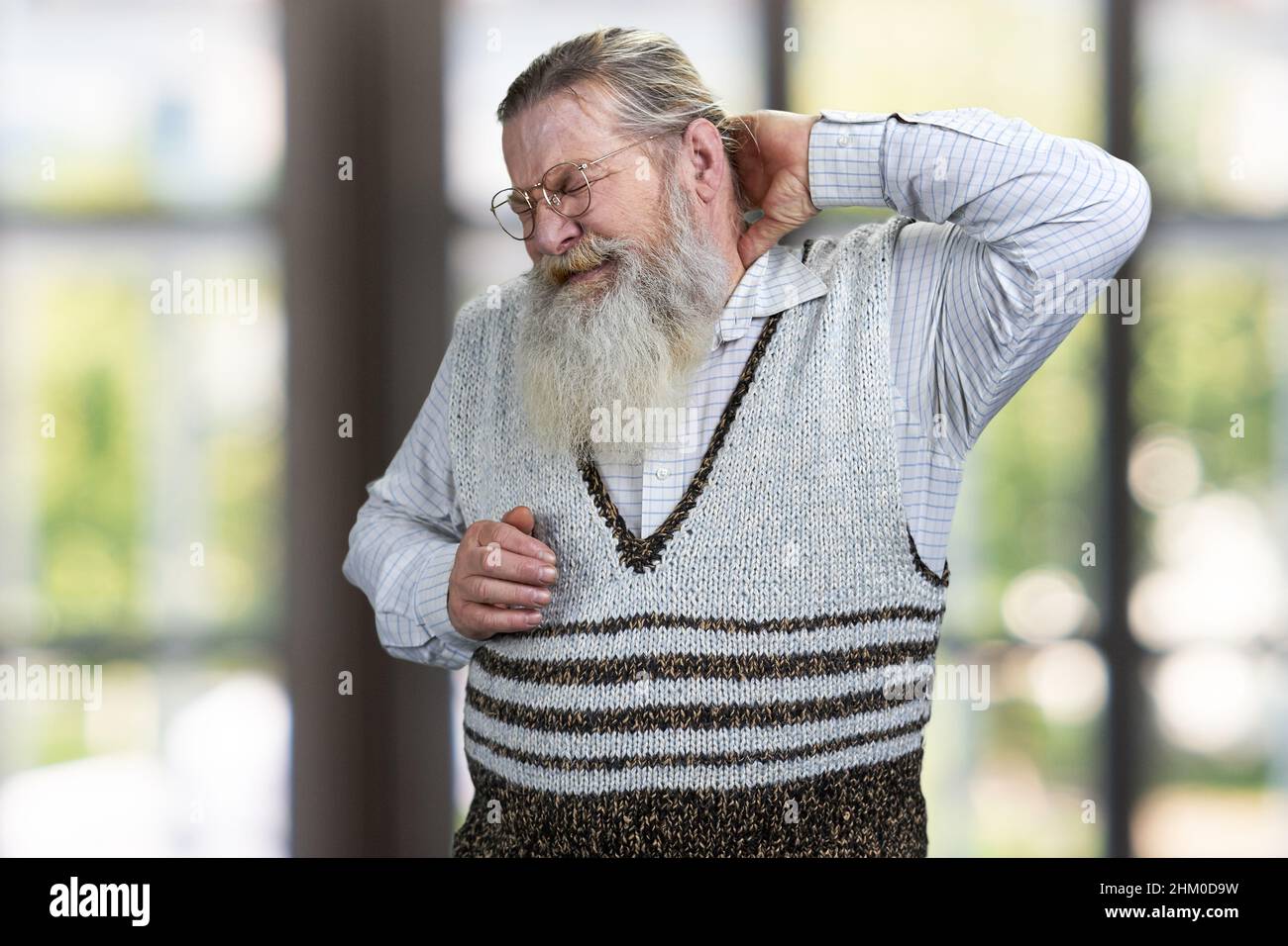 Stressed senior man holding his hand on nape. Pain concept. Health ...