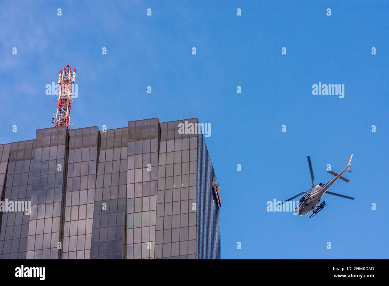 Wien, Vienna: helicopter in front of skyscraper DC Tower 1, reflecting ...