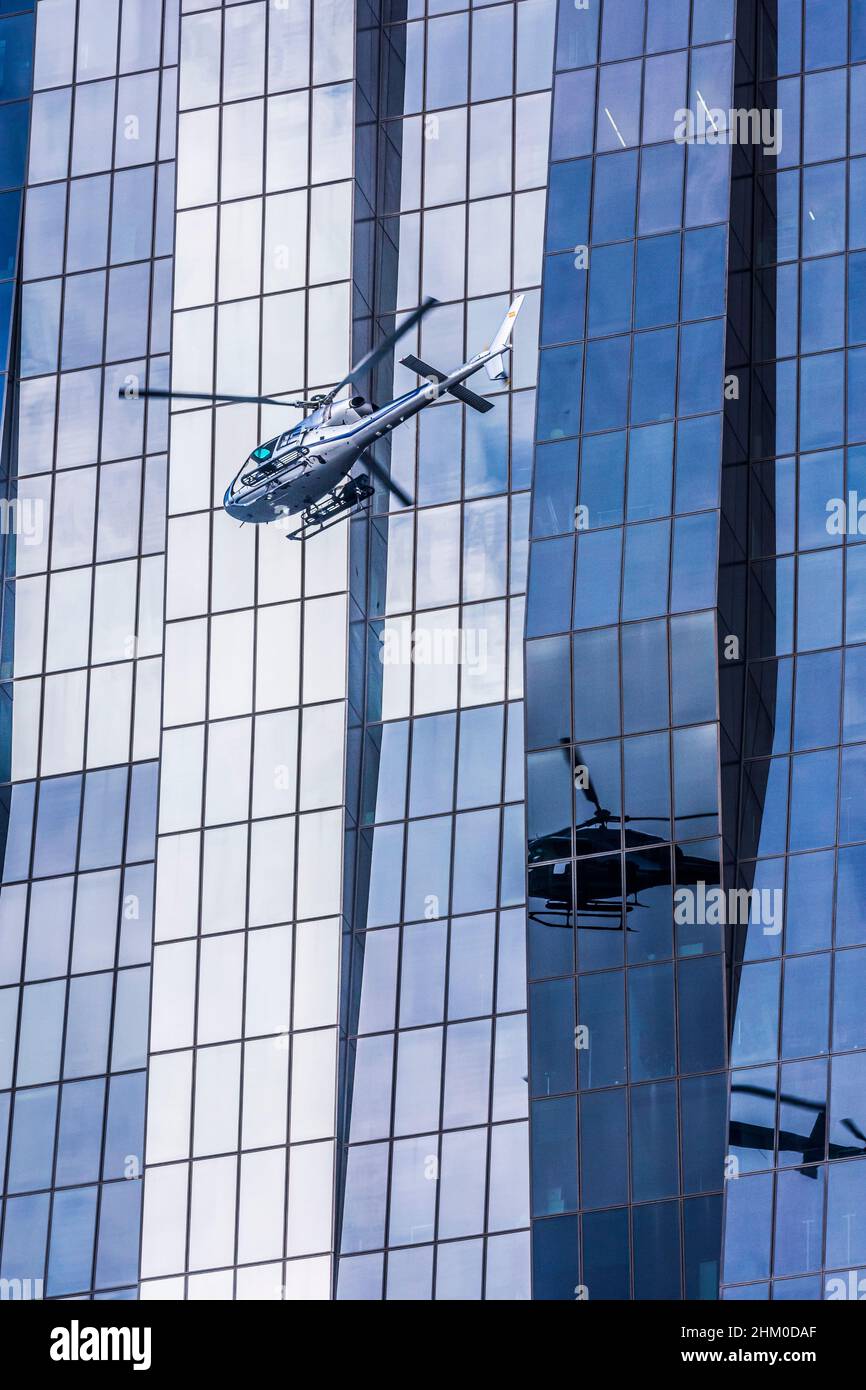 Wien, Vienna: helicopter in front of skyscraper DC Tower 1, reflecting ...
