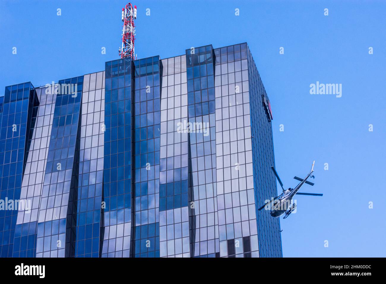 Wien, Vienna: helicopter in front of skyscraper DC Tower 1, reflecting ...