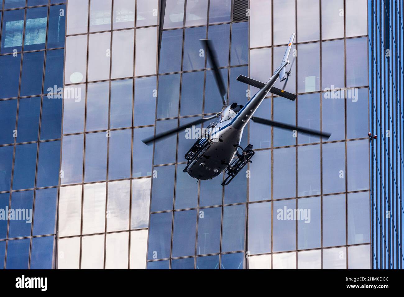 Wien, Vienna: helicopter in front of skyscraper DC Tower 1, reflecting ...