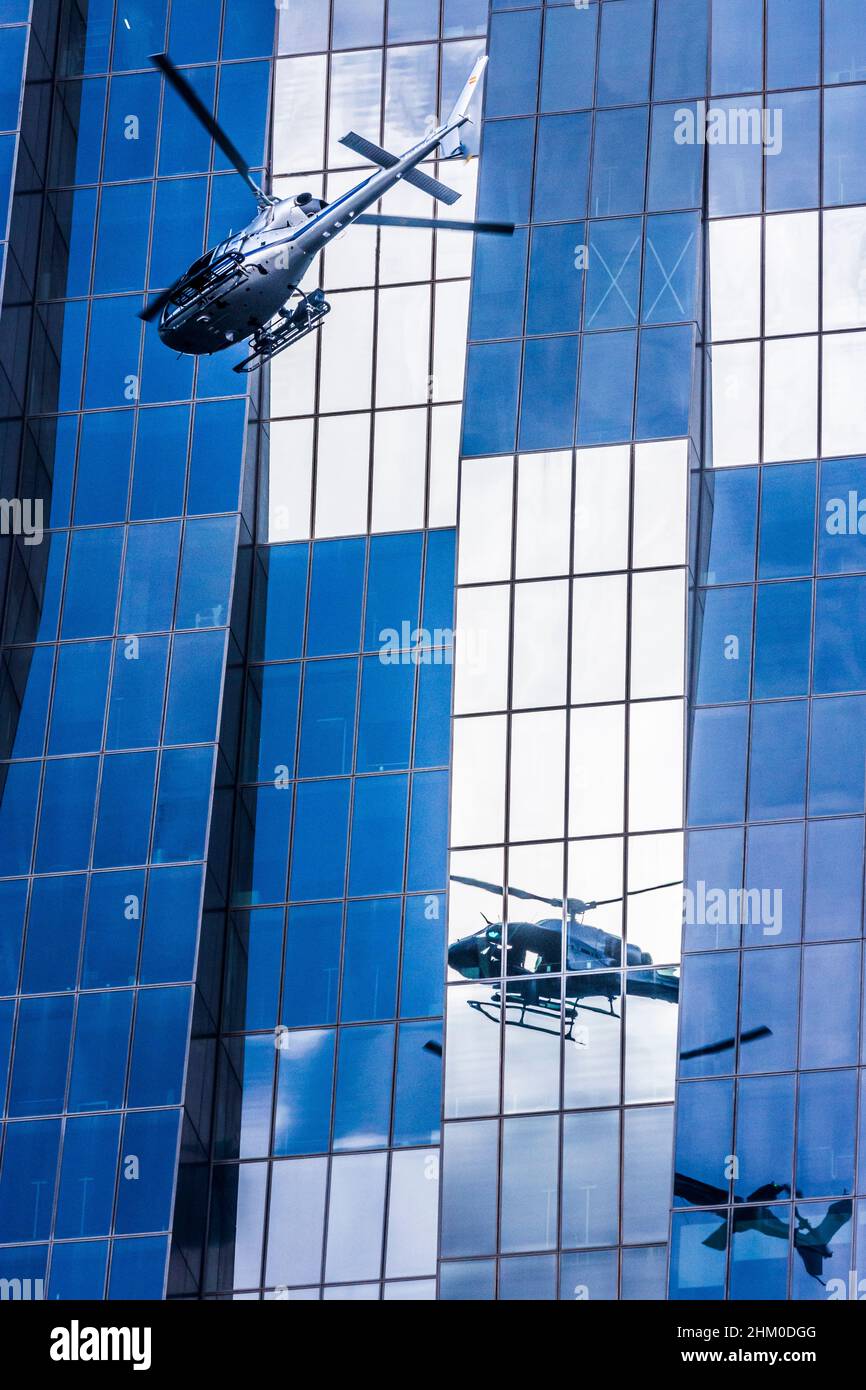 Wien, Vienna: helicopter in front of skyscraper DC Tower 1, reflecting ...
