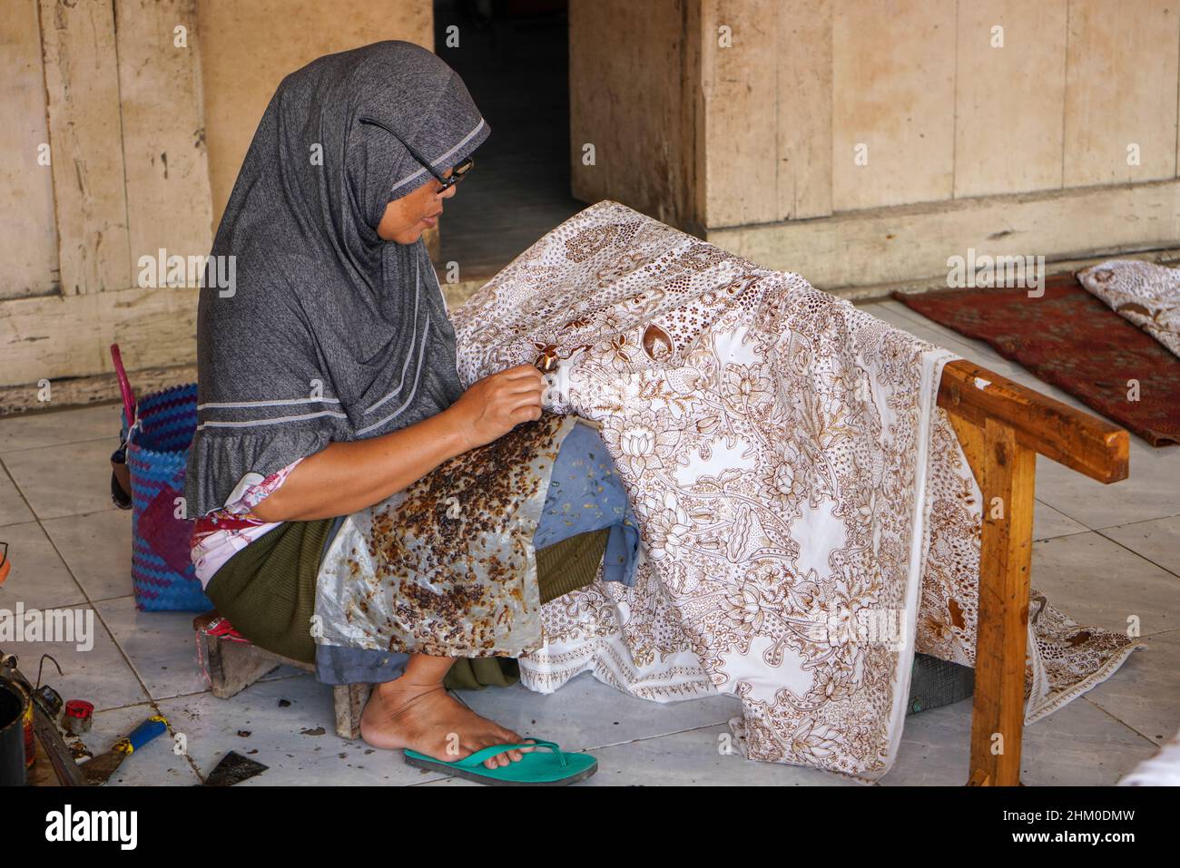 The technique of making batik by writing using a canting tool. Canting ...
