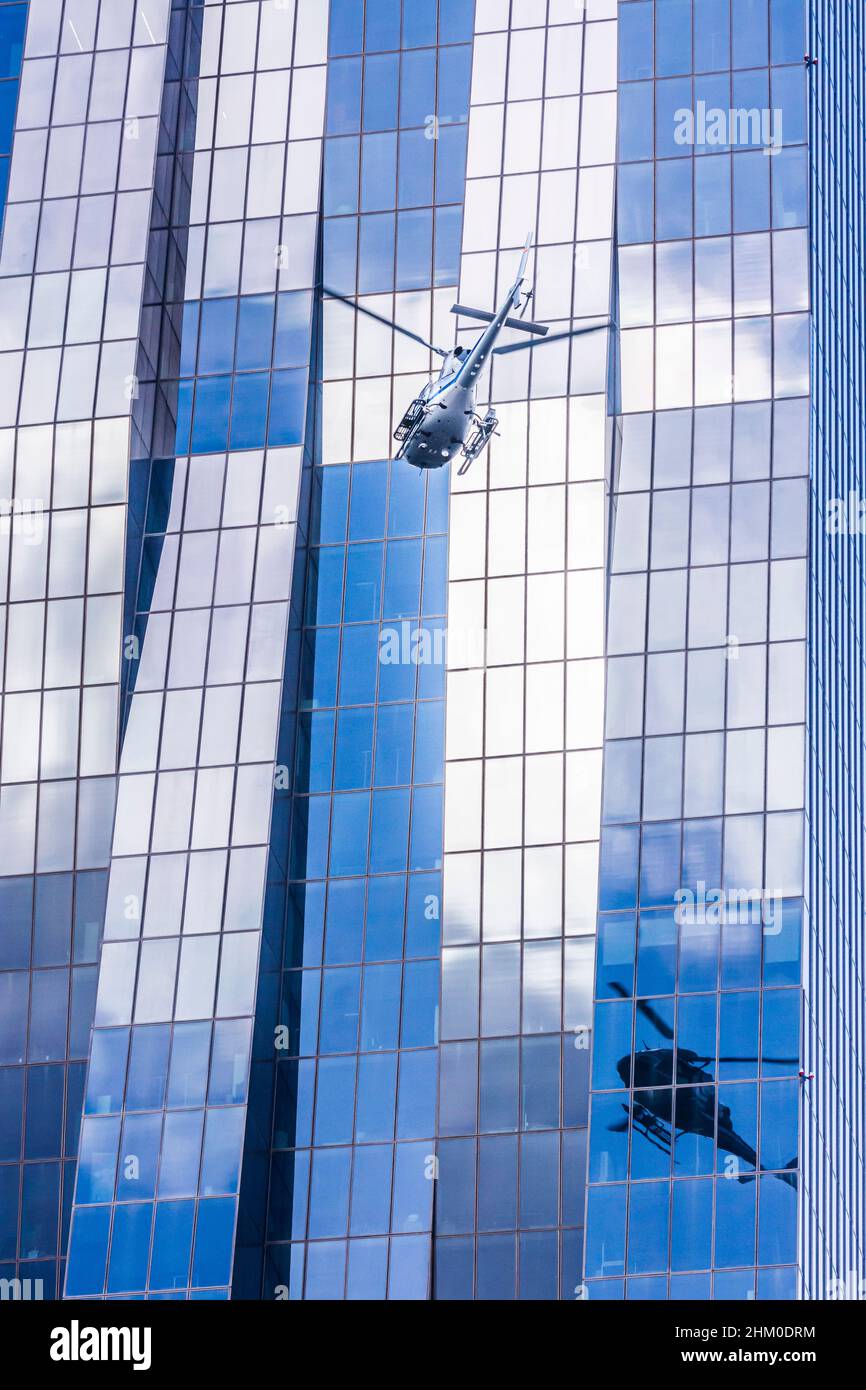 Wien, Vienna: helicopter in front of skyscraper DC Tower 1, reflecting ...
