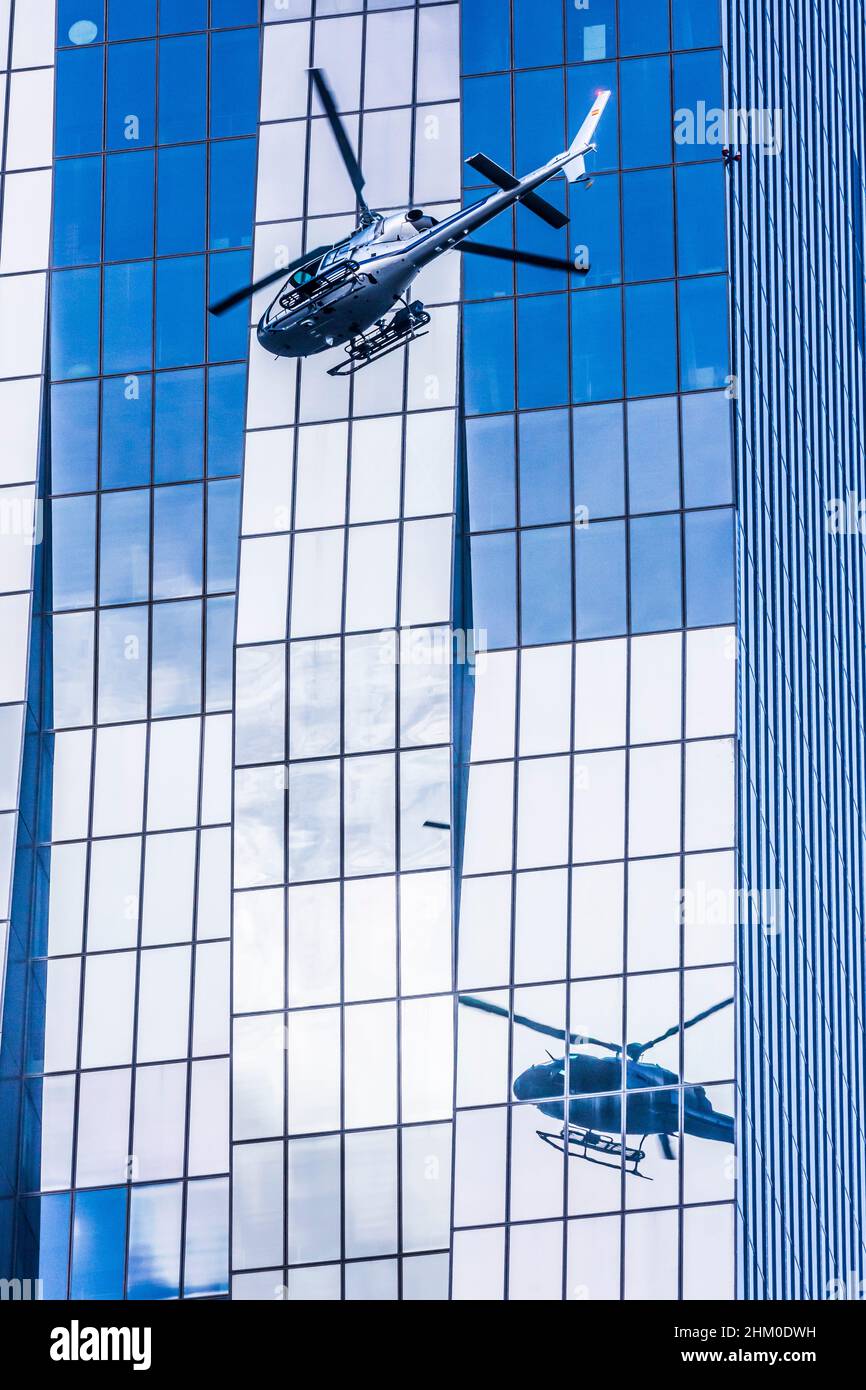 Wien, Vienna: helicopter in front of skyscraper DC Tower 1, reflecting ...