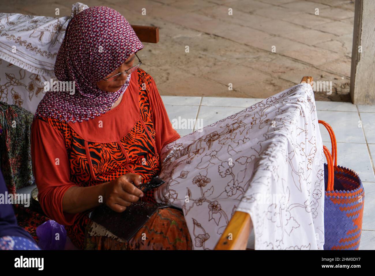 The technique of making batik by writing using a canting tool. Canting ...