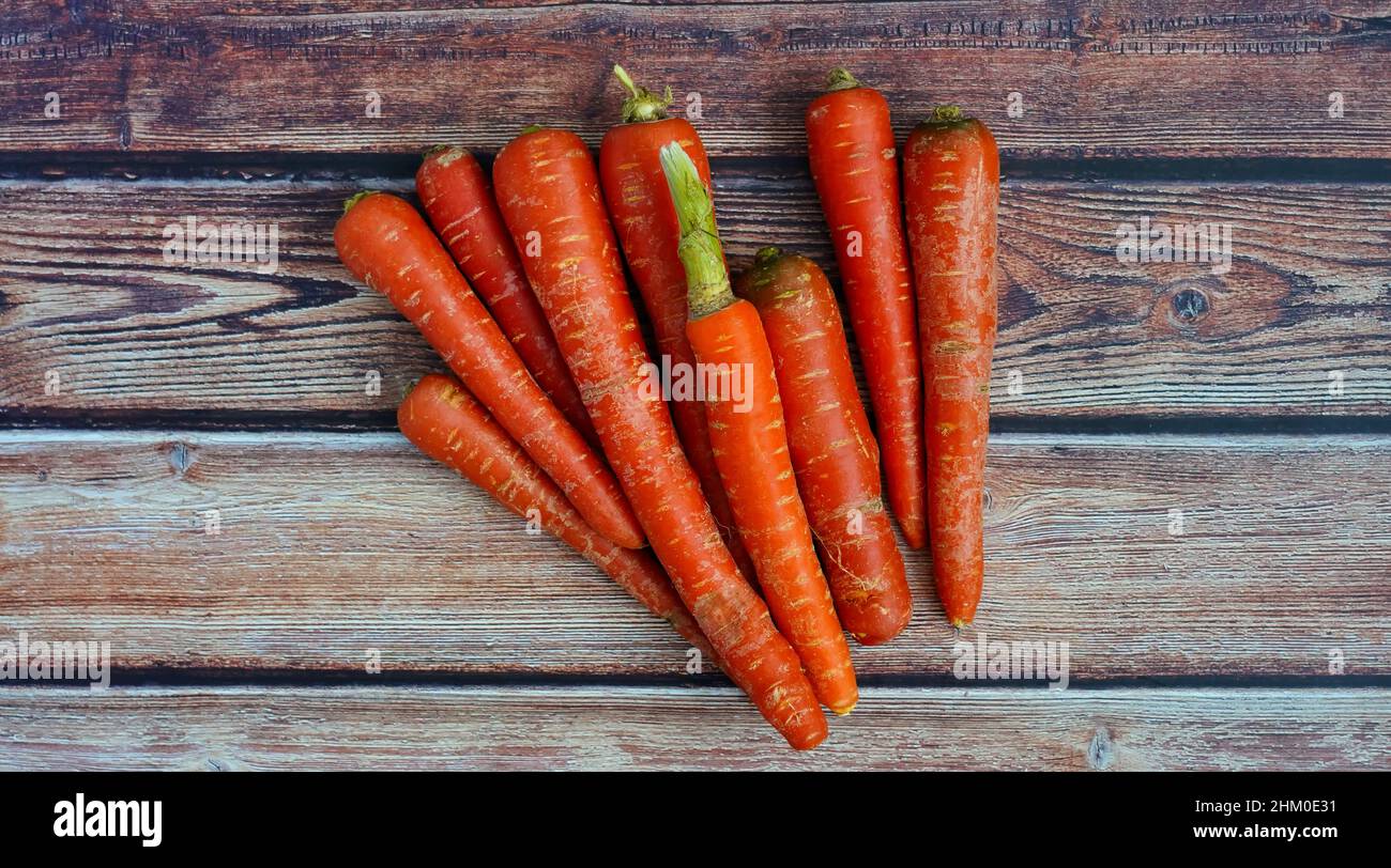 Organic dark orange carrots on a wooden table Stock Photo - Alamy