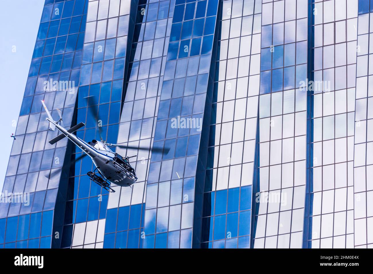 Wien, Vienna: helicopter in front of skyscraper DC Tower 1, reflecting ...