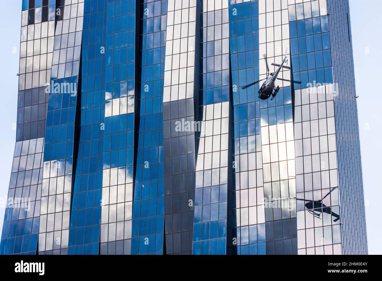 Wien, Vienna: helicopter in front of skyscraper DC Tower 1, reflecting ...