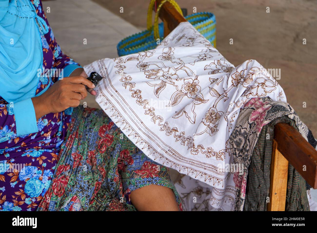 The technique of making batik by writing using a canting tool. Canting ...