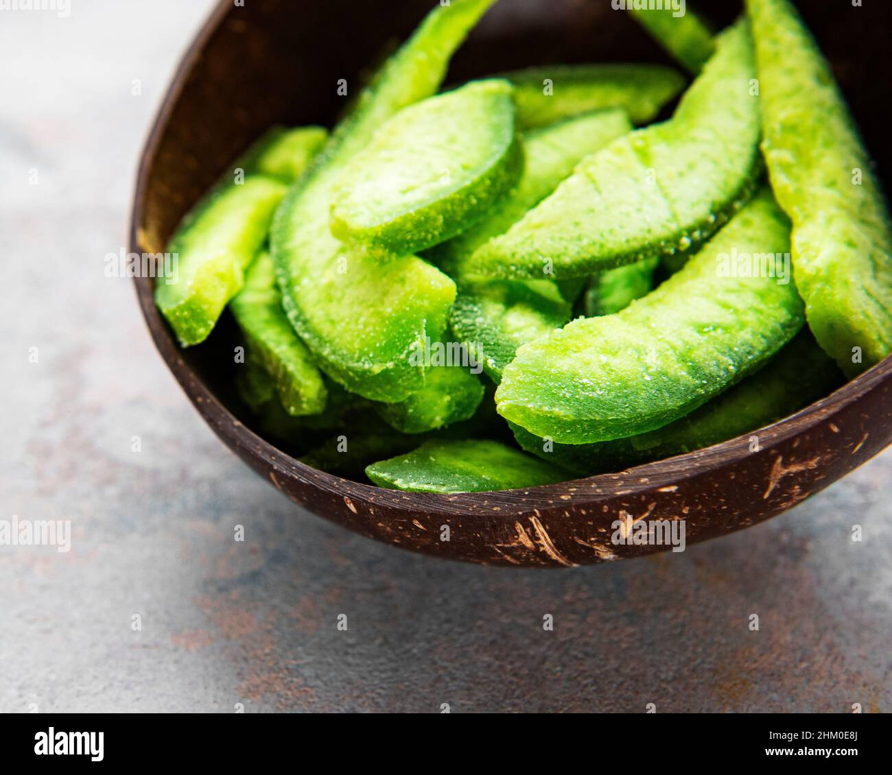 Dry chunks of pomelo on a plate on a grey concrete background Stock ...