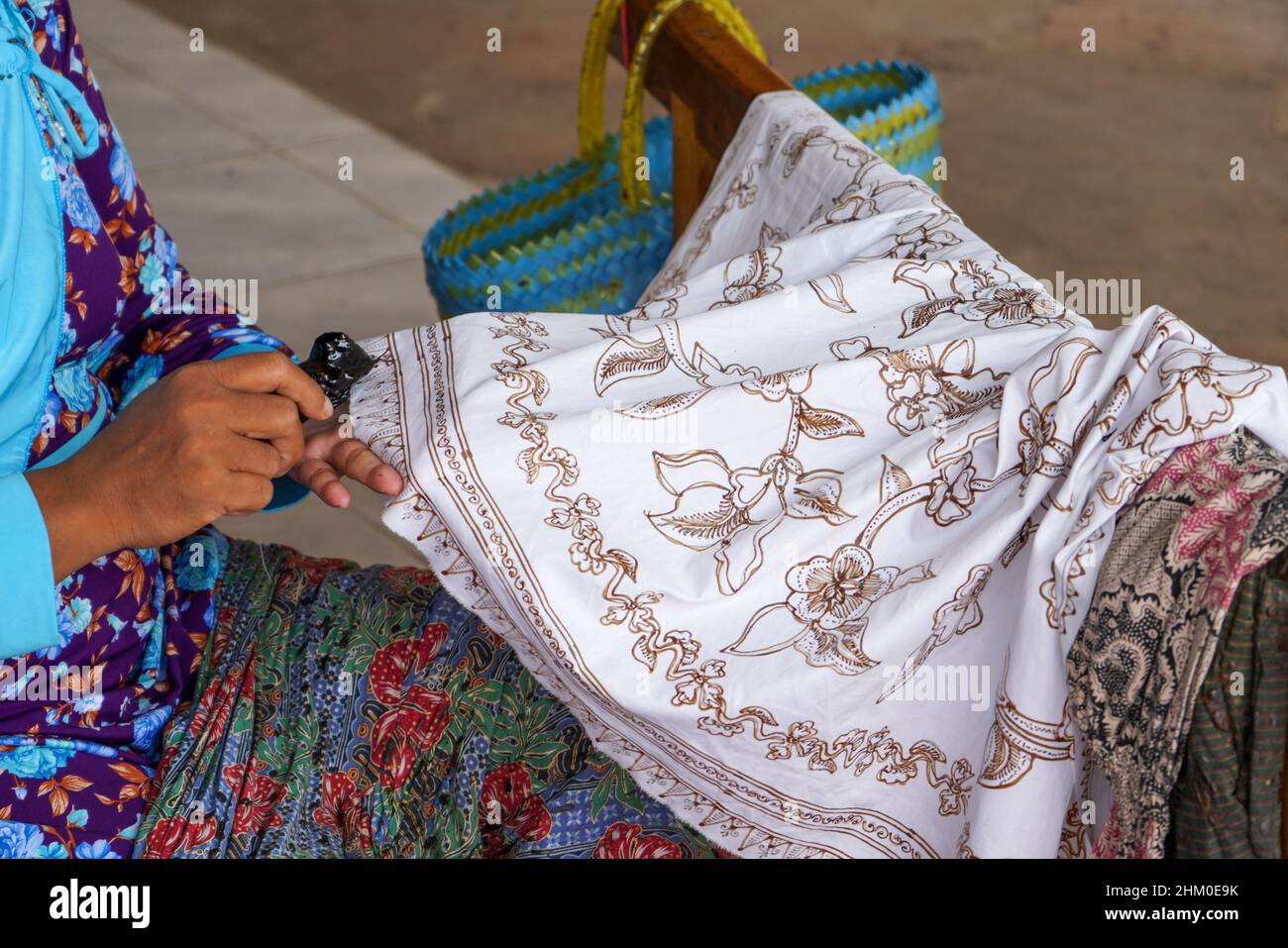 The technique of making batik by writing using a canting tool. Canting ...