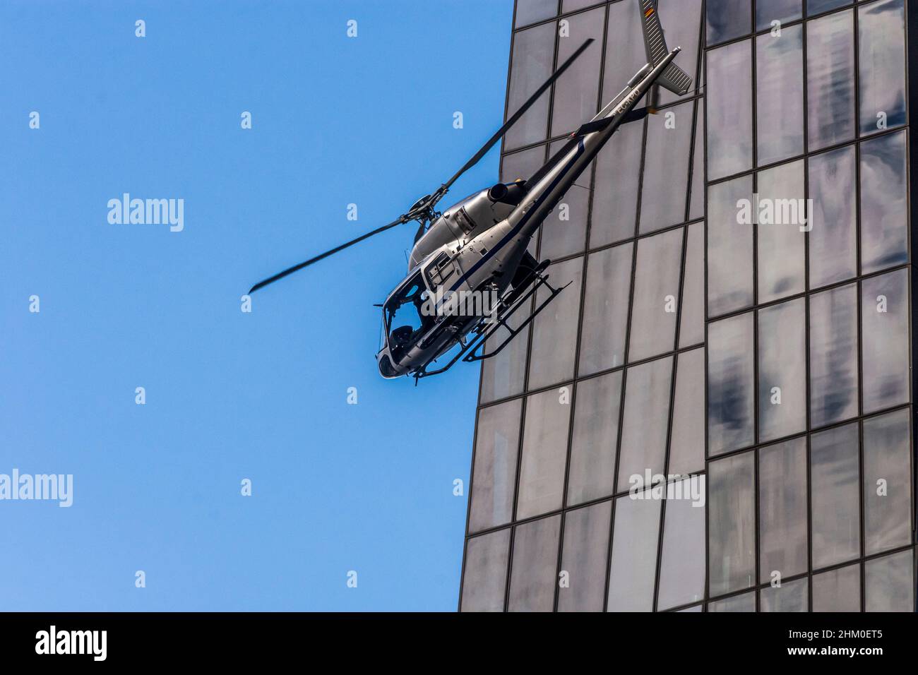 Wien, Vienna: helicopter in front of skyscraper DC Tower 1, reflecting ...