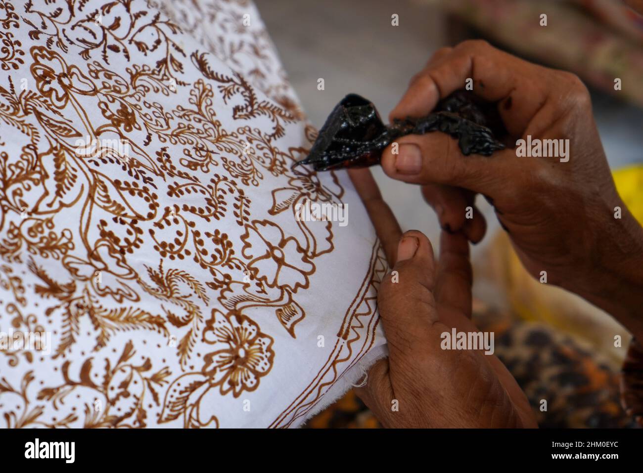 The technique of making batik by writing using a canting tool. Canting ...