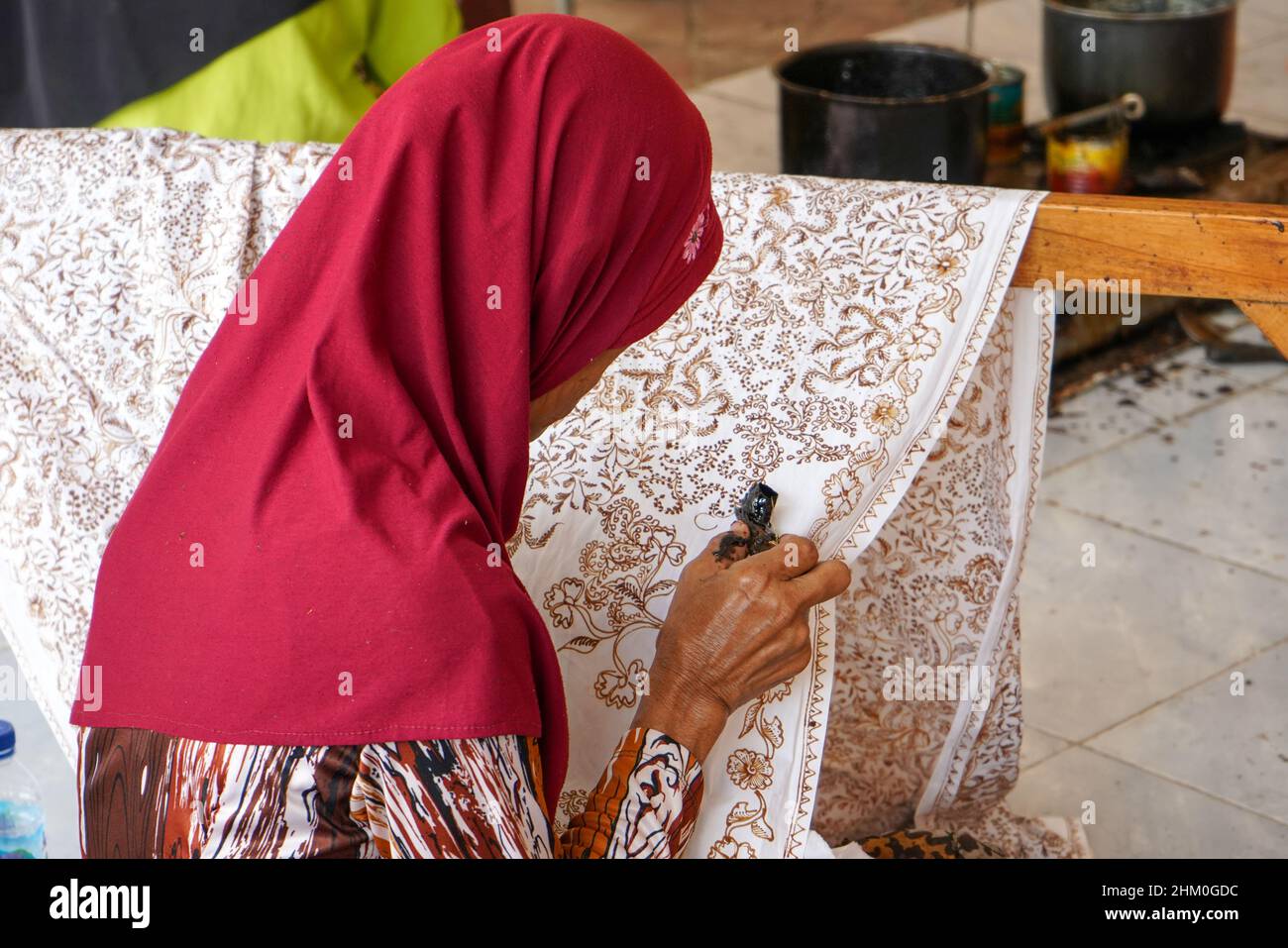 The technique of making batik by writing using a canting tool. Canting ...