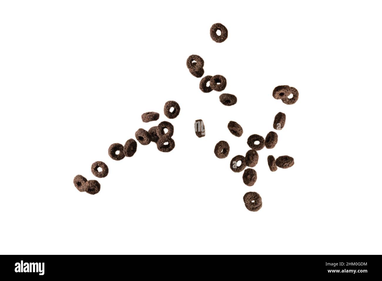 Chocolate rings cereal spill out into a bowl. Breakfast. Isolated on a ...