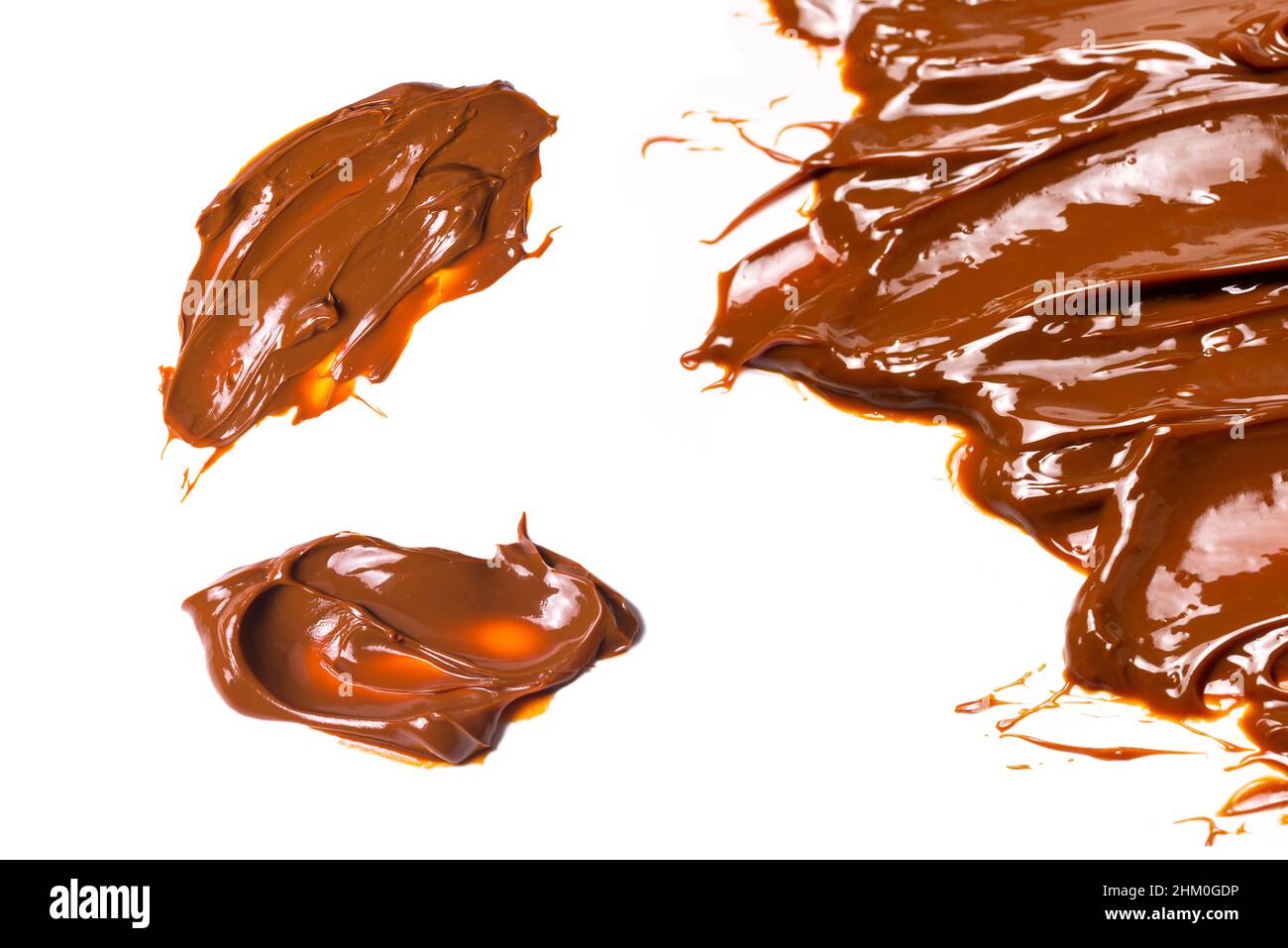 Melted tasty caramel splashes isolated on white background Stock Photo ...