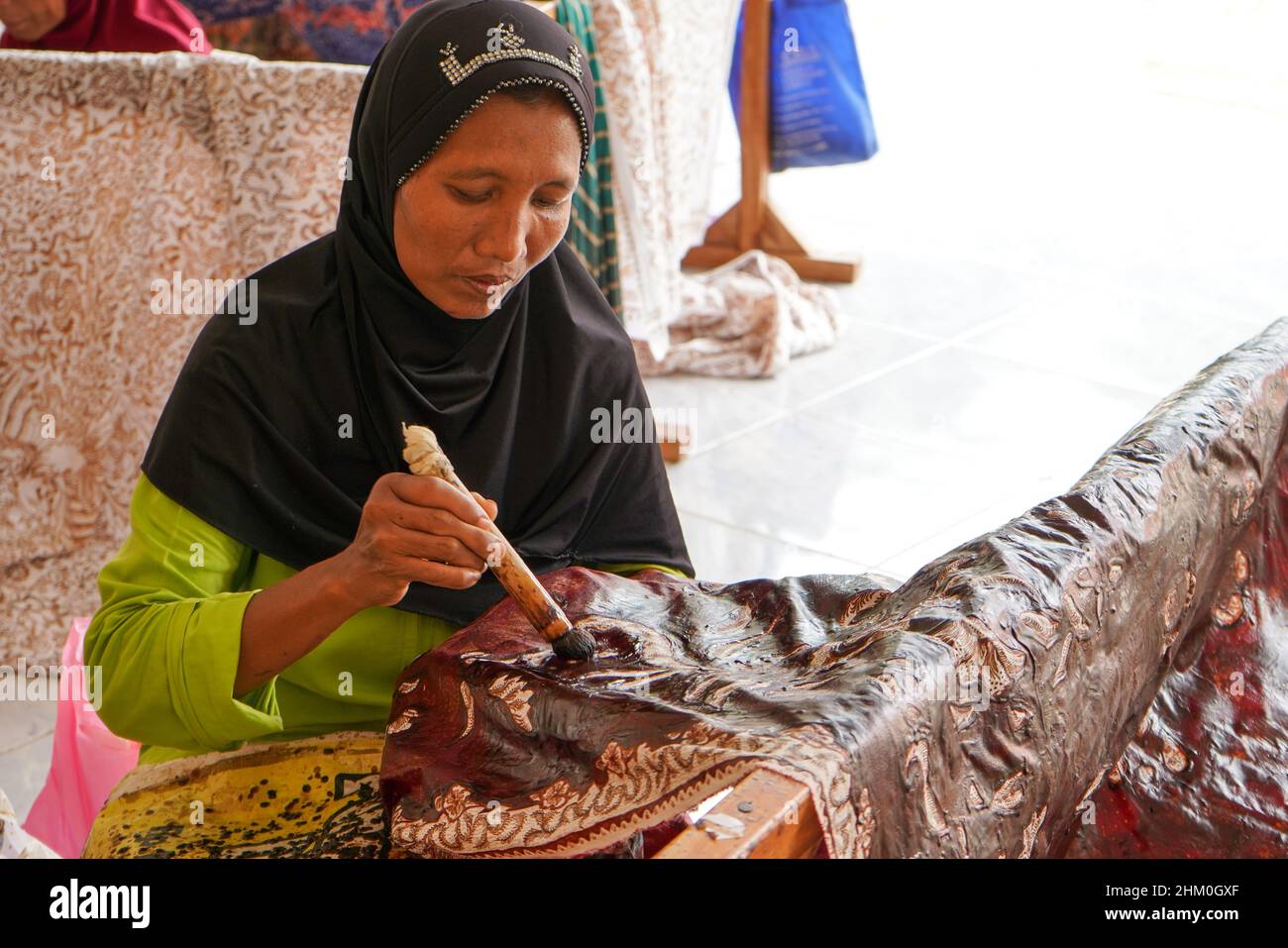 The technique of making batik by writing using a canting tool. Canting ...
