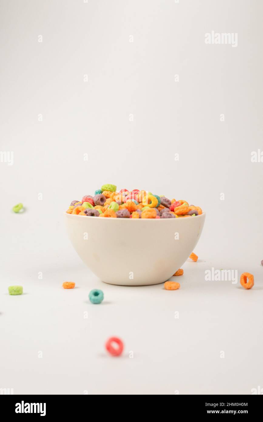Colorful cereal box for morning breakfast. Corn flakes falling to the ...