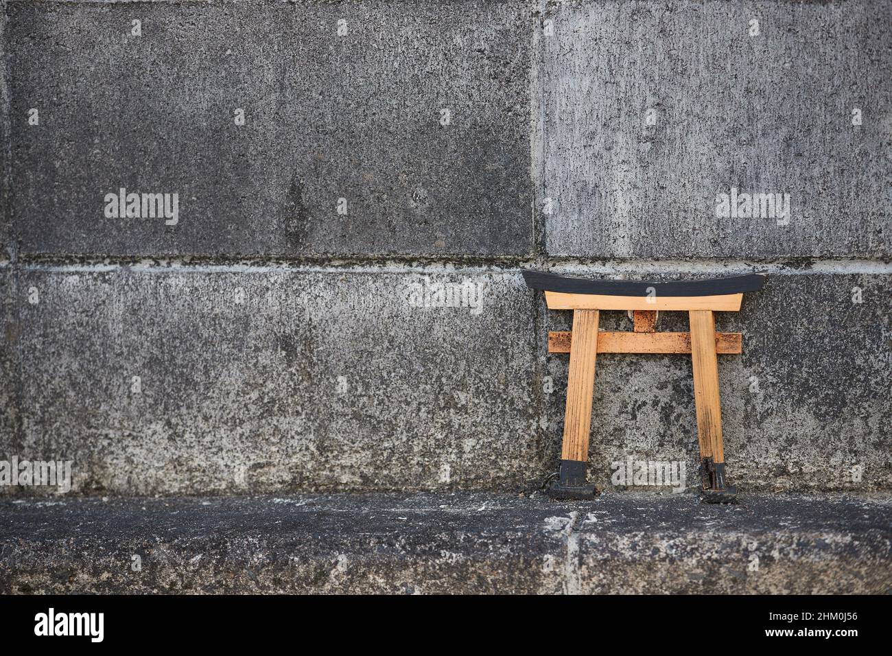 Tiny Shinto shrine torii gate up on a concrete wall Stock Photo - Alamy