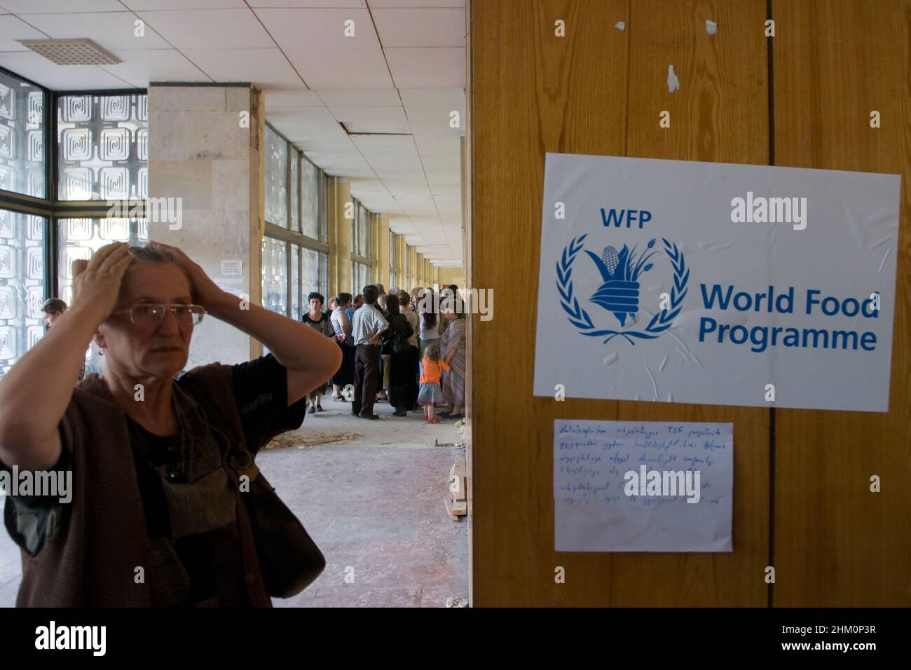 Displaced Georgian woman enters the temporary office of WFP Programme ...