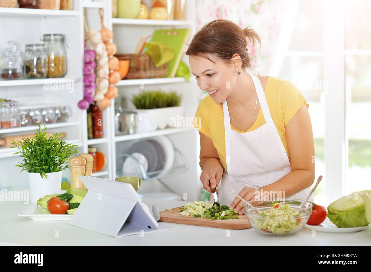Portrait of beautiful young woman cooking in kitchen Stock Photo - Alamy