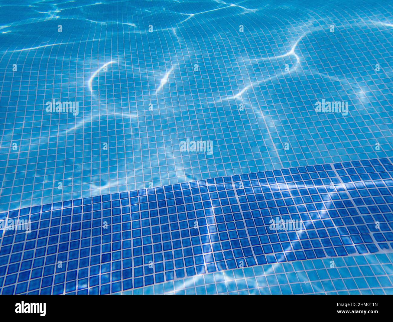 Underwater image of tiled Swimming pool floor with water reflections ...