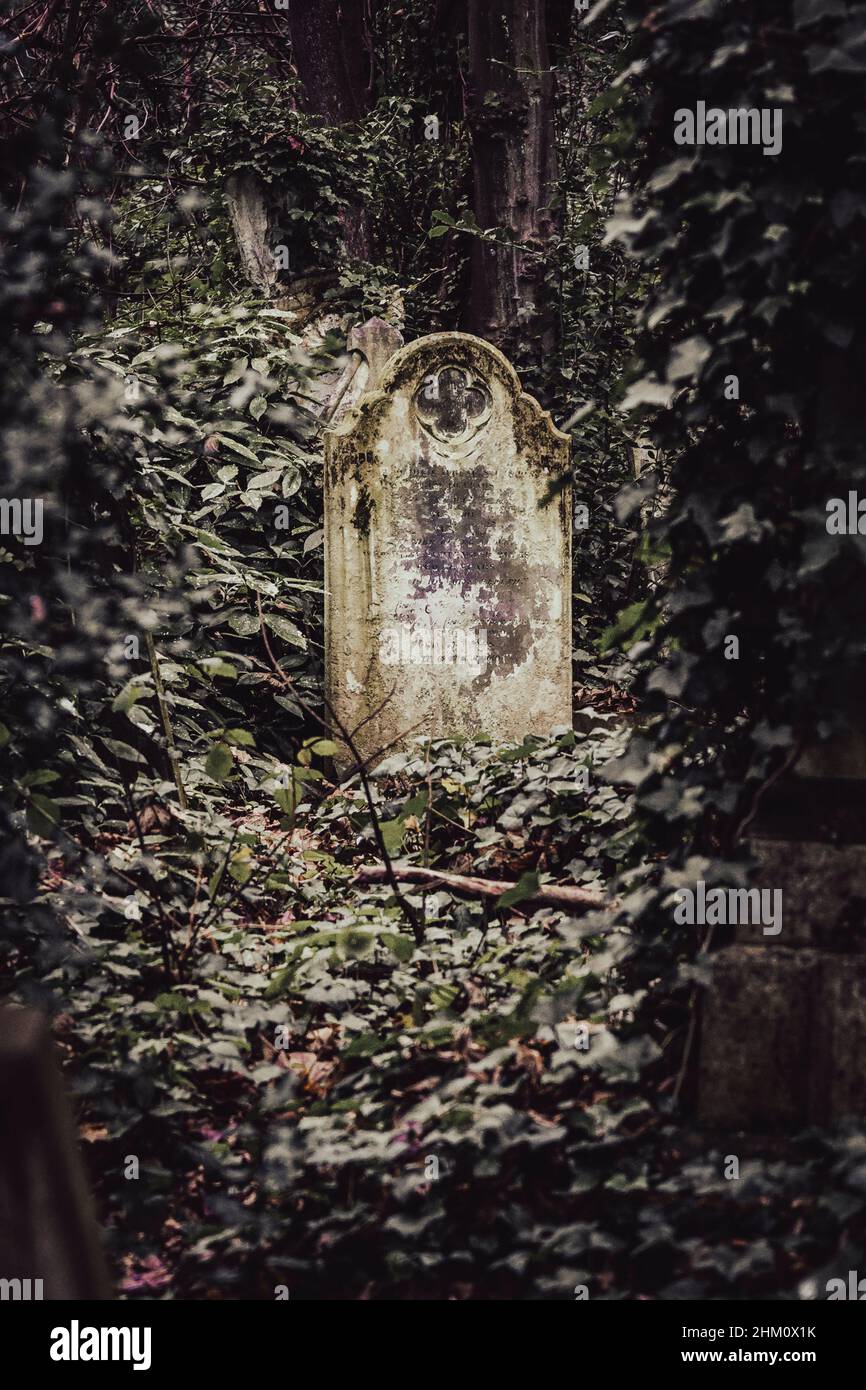Dilapidated overgrown gravestone, Nunhead Cemetery, London, England, UK ...