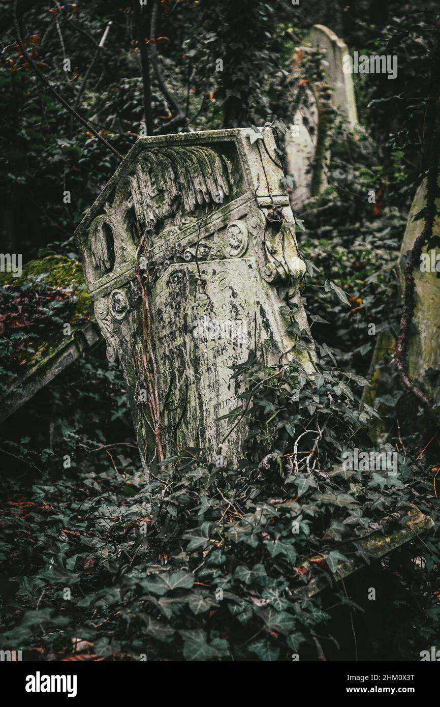 Dilapidated overgrown gravestone, Nunhead Cemetery, London, England, UK ...