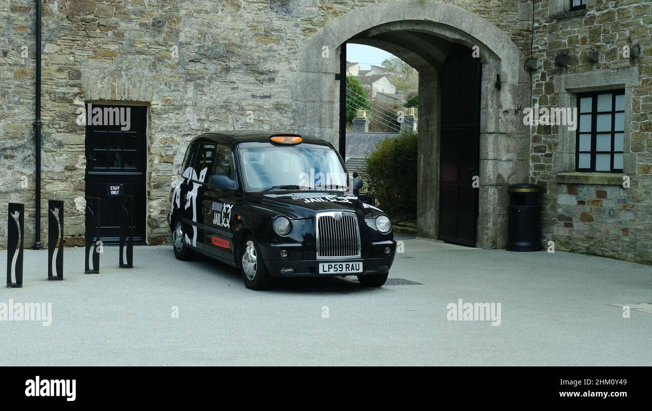 A black taxi outside Bodmin Jail Hotel Cornwall with the hotel logo on ...