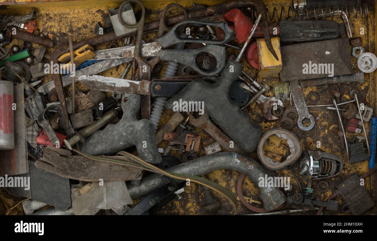 Old rusty tools are in the drawer. A dirty box with construction tools ...