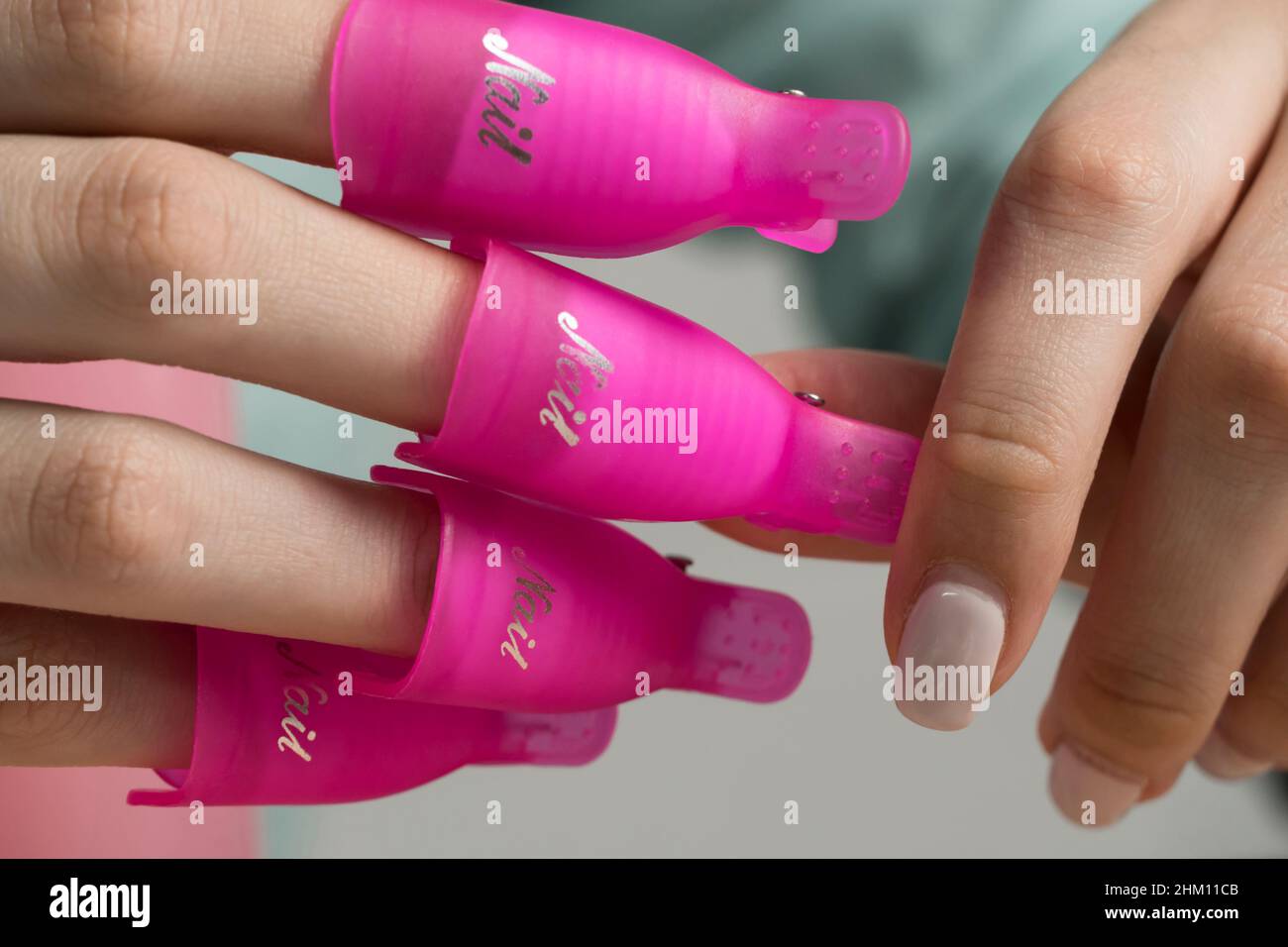 Remove the old gel polish using nail clips. The girl does her own ...