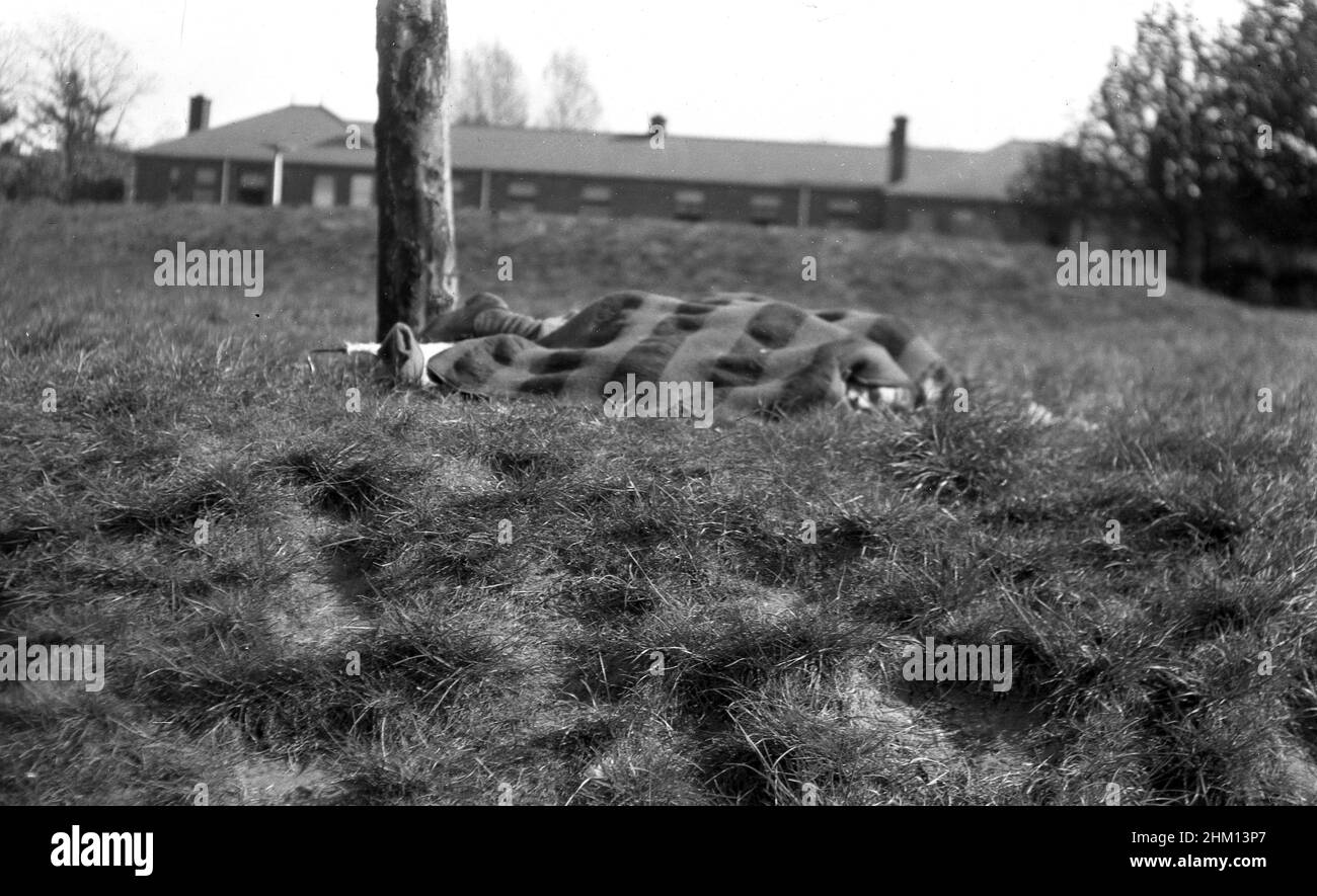 1942, historical, two cub scouts lying under a blanket in the grounds ...