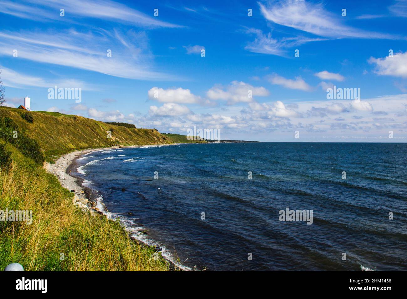 Windy bay below Ales stenar in Österlen Sweden on a bright summer day ...
