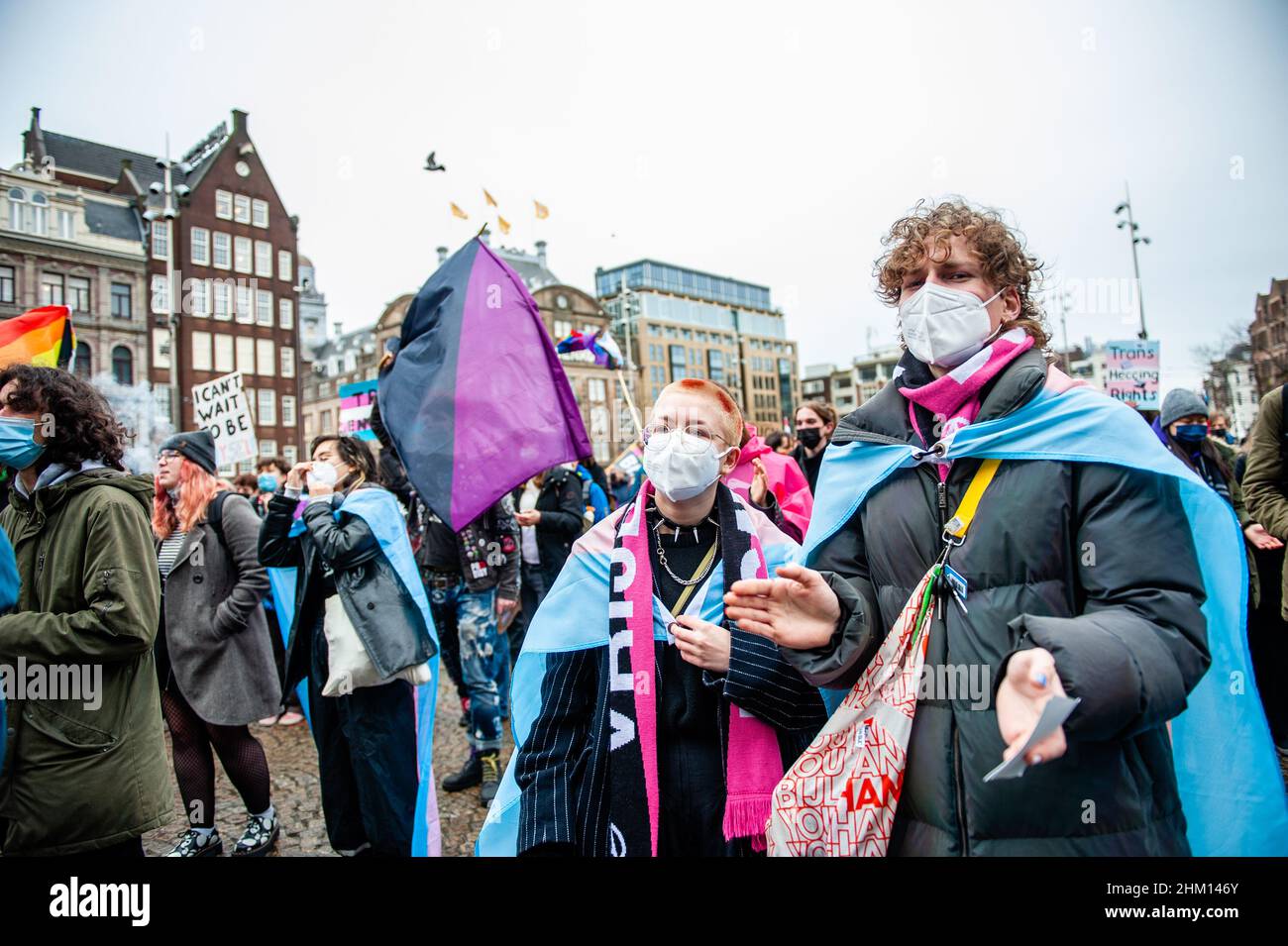 Protesters are seen clapping after a speech in support of trans people ...