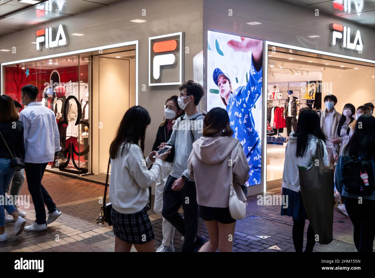 Pedestrians walk past the Italian sporting goods brand Fila store in ...