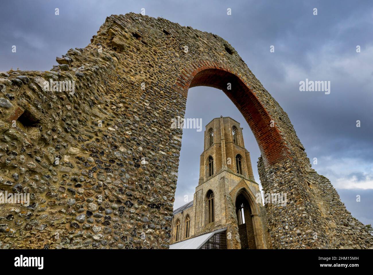 The bell tower of Wymondham Abbey through the ruins of the east abbey ...